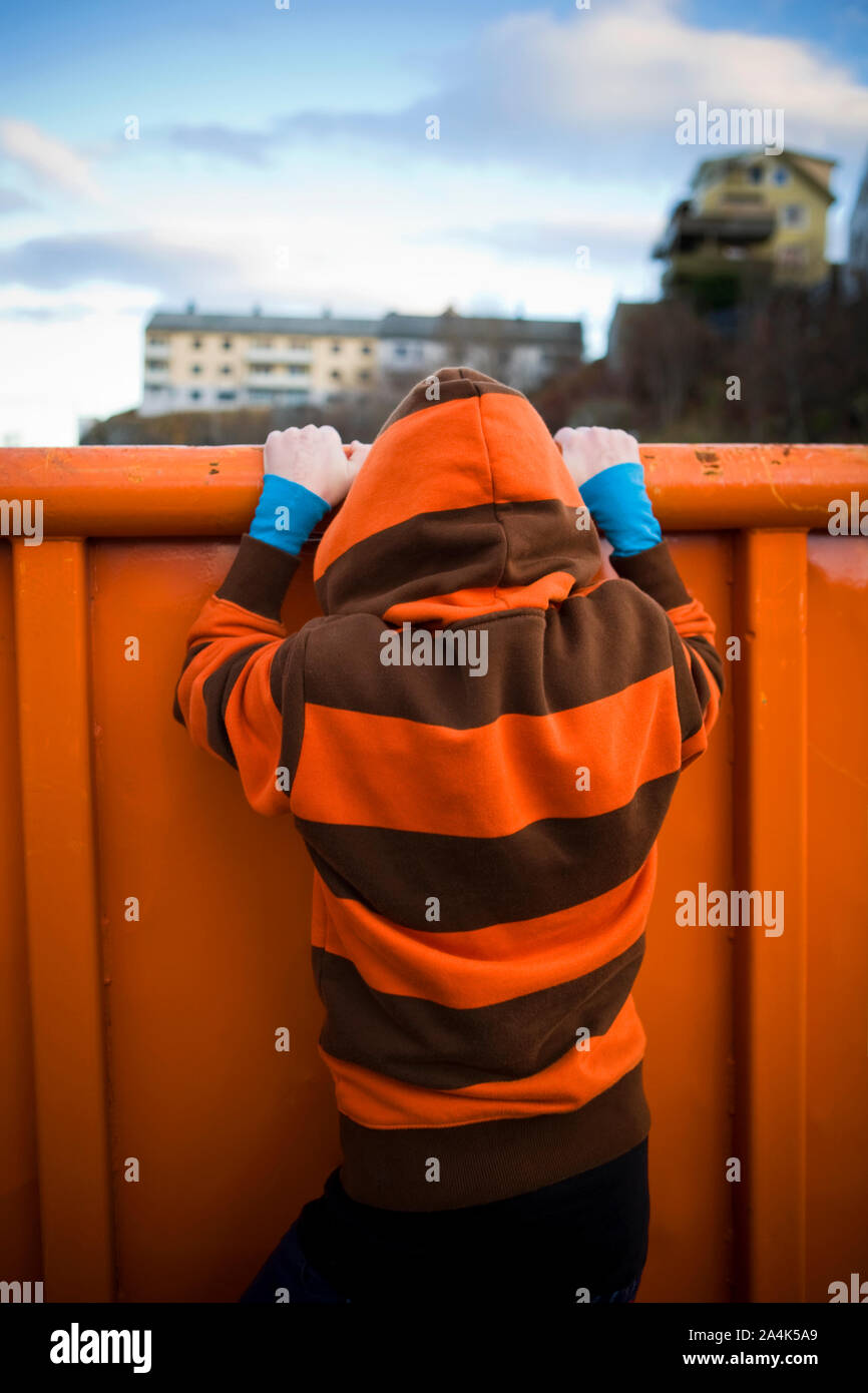 Boy climbing a container Stock Photo - Alamy