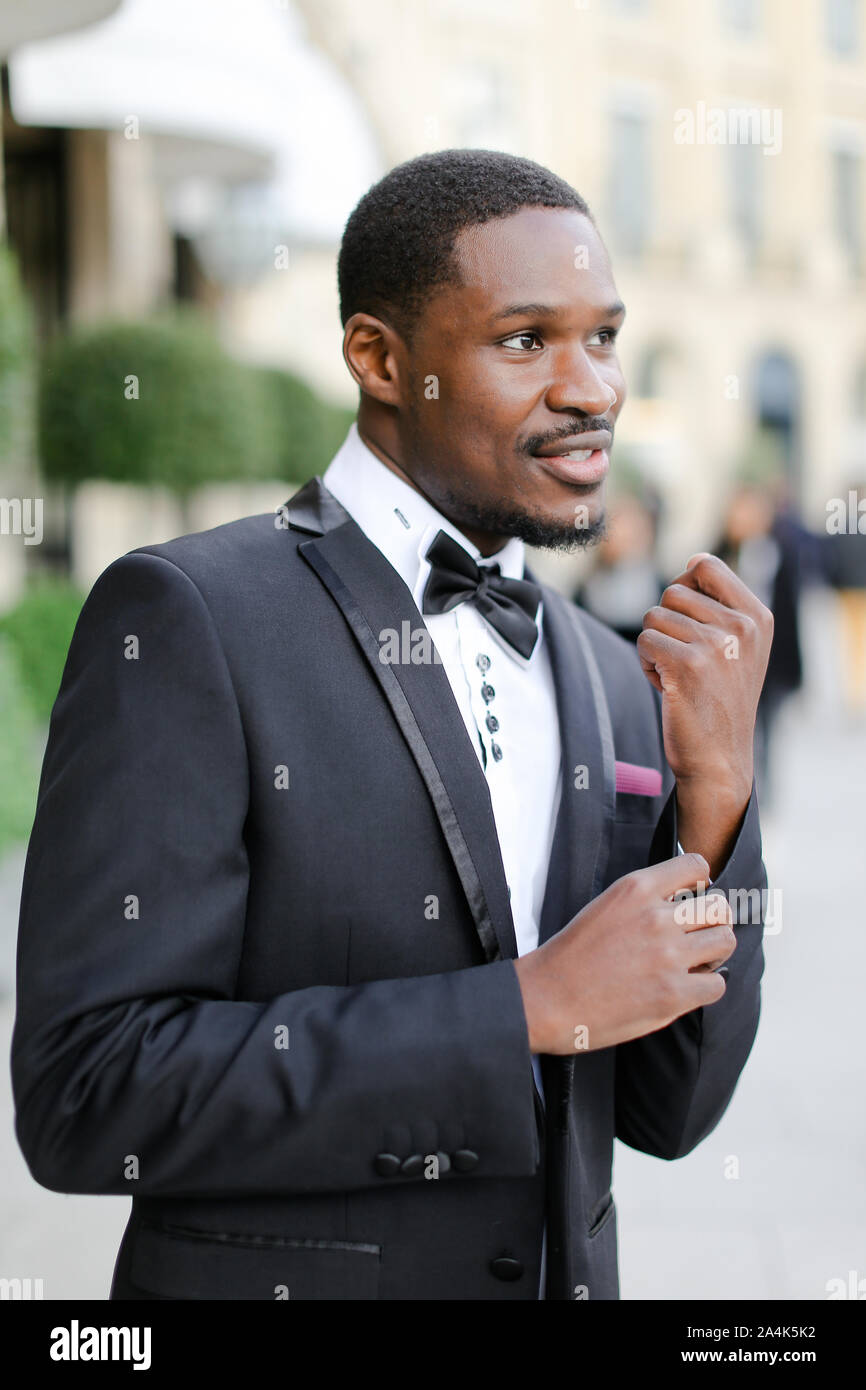 Afro american handsome man wearing suit and smiling Stock Photo - Alamy