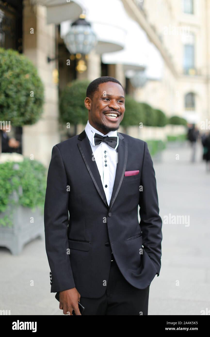 Afro american man wearing suit and standing near building Stock Photo ...