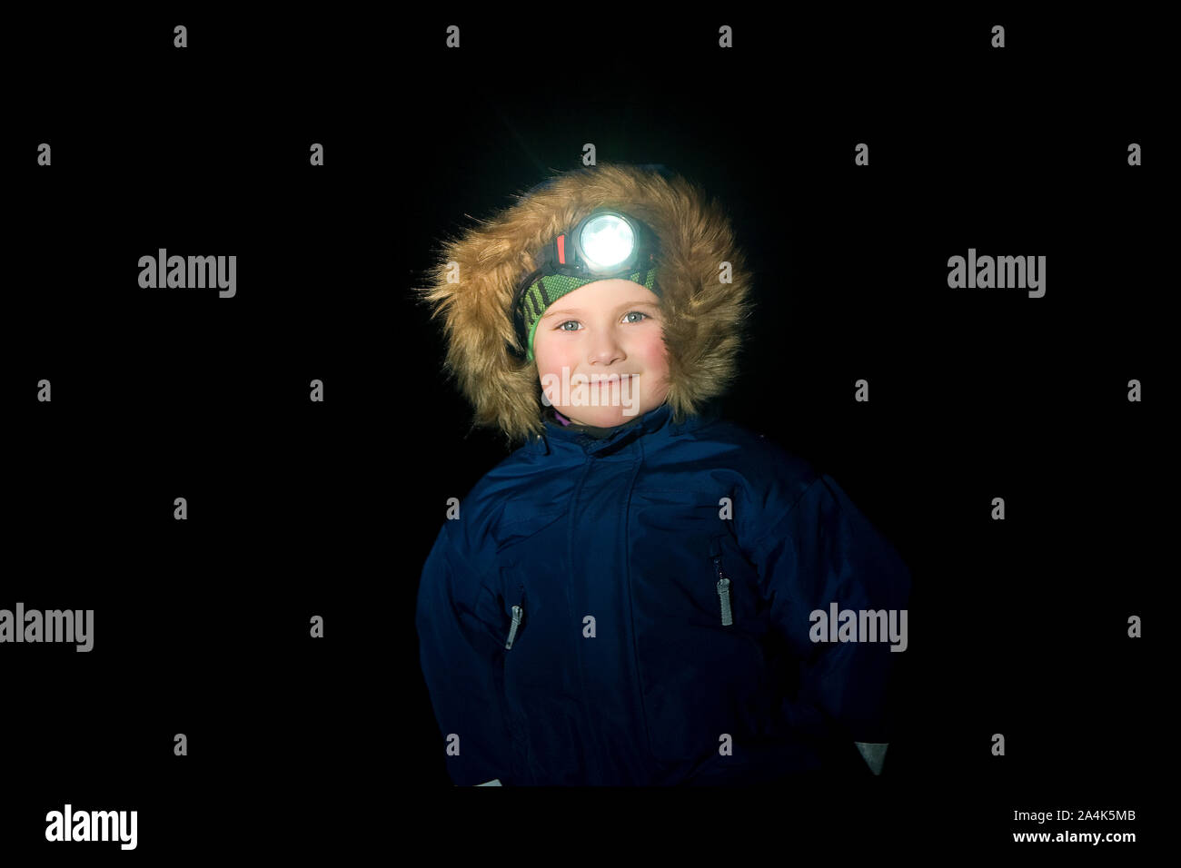 portrait of child wearing flashlight on head Stock Photo - Alamy