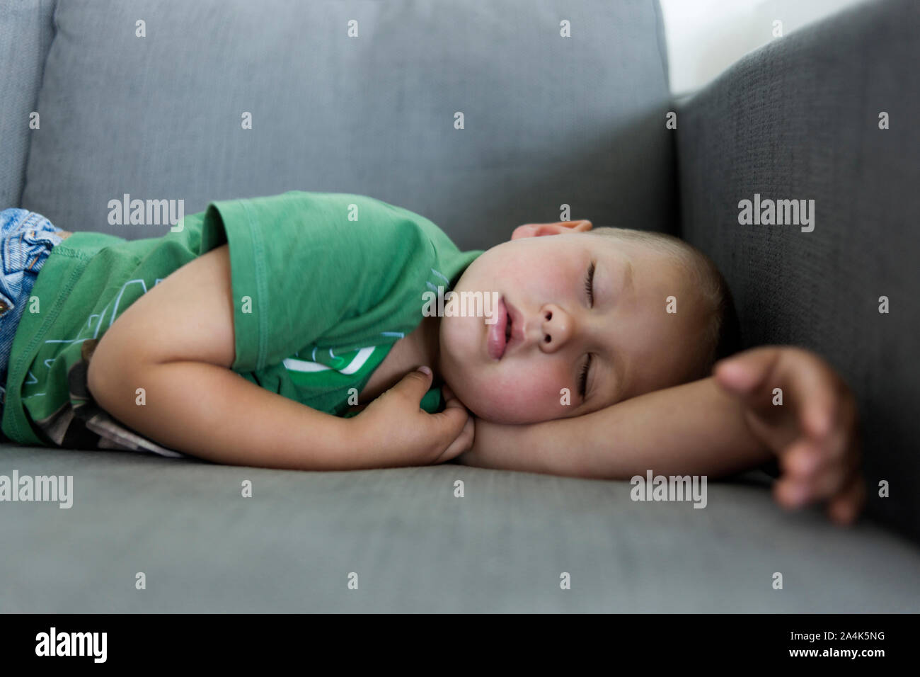 Portrait Of Boy Sleeping On Sofa Stock Photo - Alamy