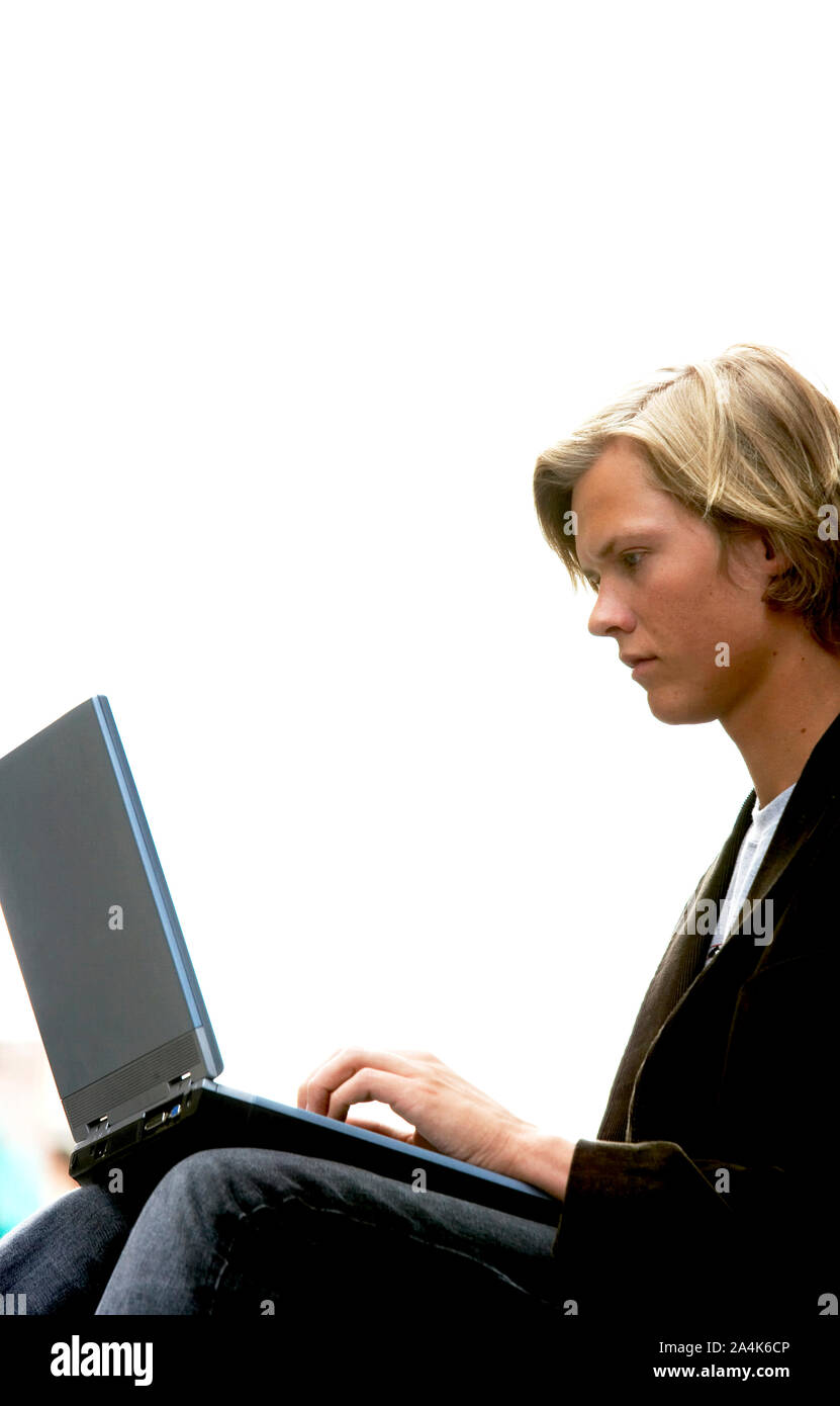 Student sitting with laptop - studying - concentration Stock Photo - Alamy