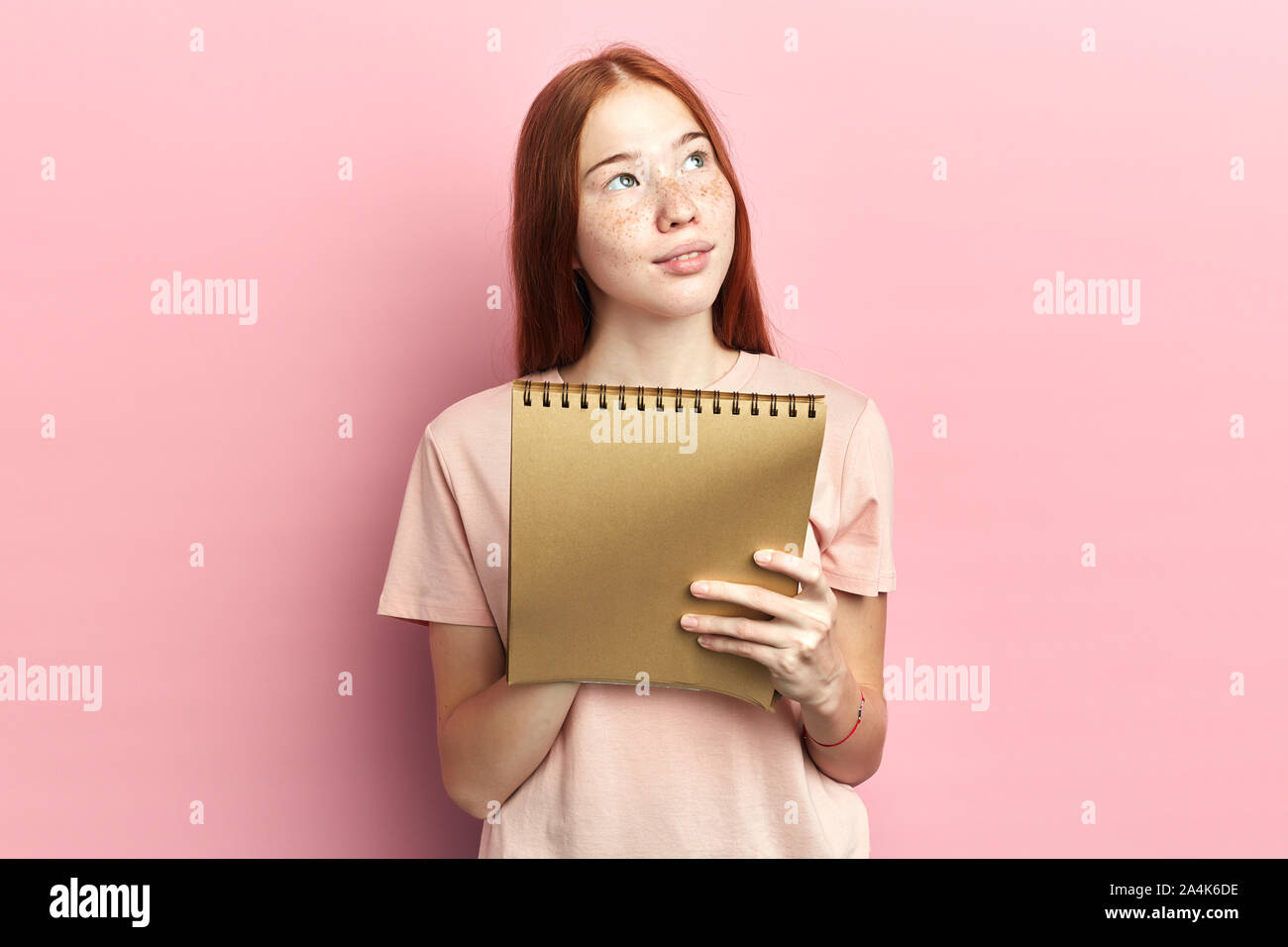 pensive thoughtful serious woman looking up, writer making up a story ...