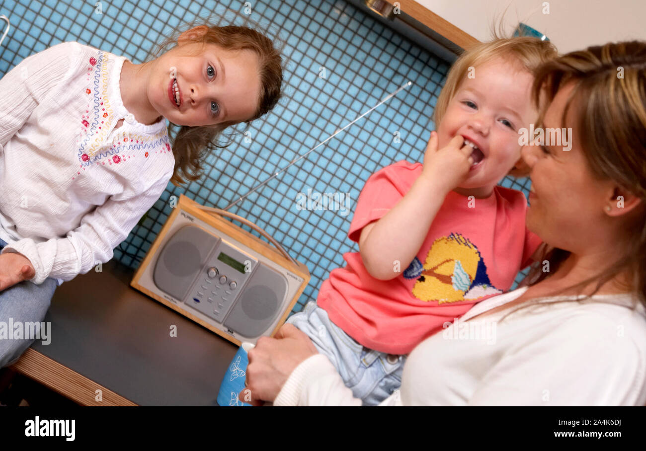Family listening to the radio Stock Photo - Alamy