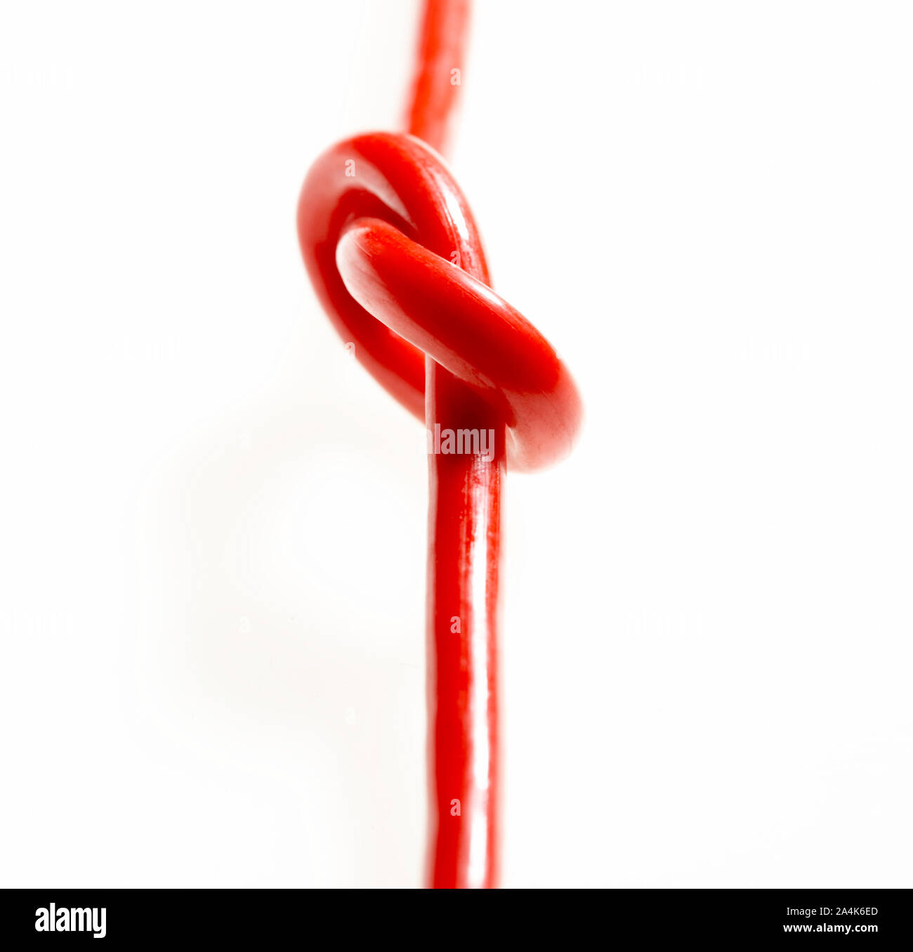 Red string/lead - knot Stock Photo - Alamy