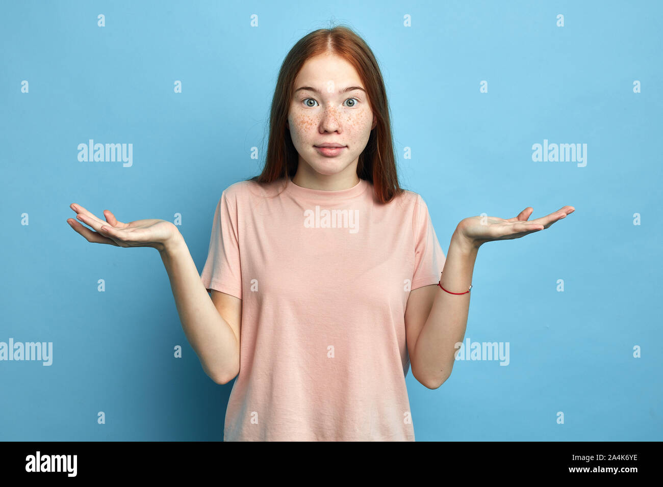 serious girl with puzzled expression, has doubts about her choice ...