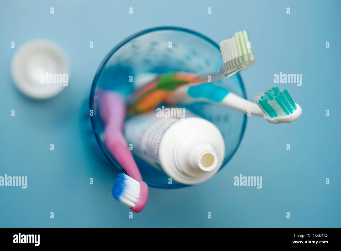 Toothbrushes and toothpaste in glass Stock Photo - Alamy