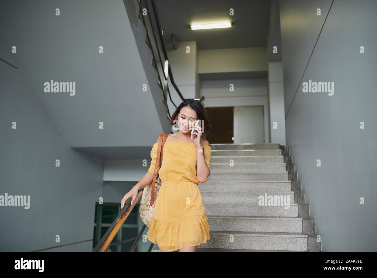 Woman walking downstairs hi-res stock photography and images - Alamy