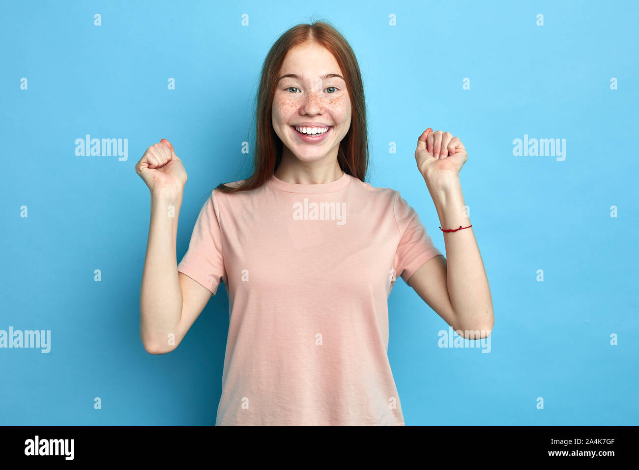 excited teenager with overjoyed expression, rejoices her success, keeps ...