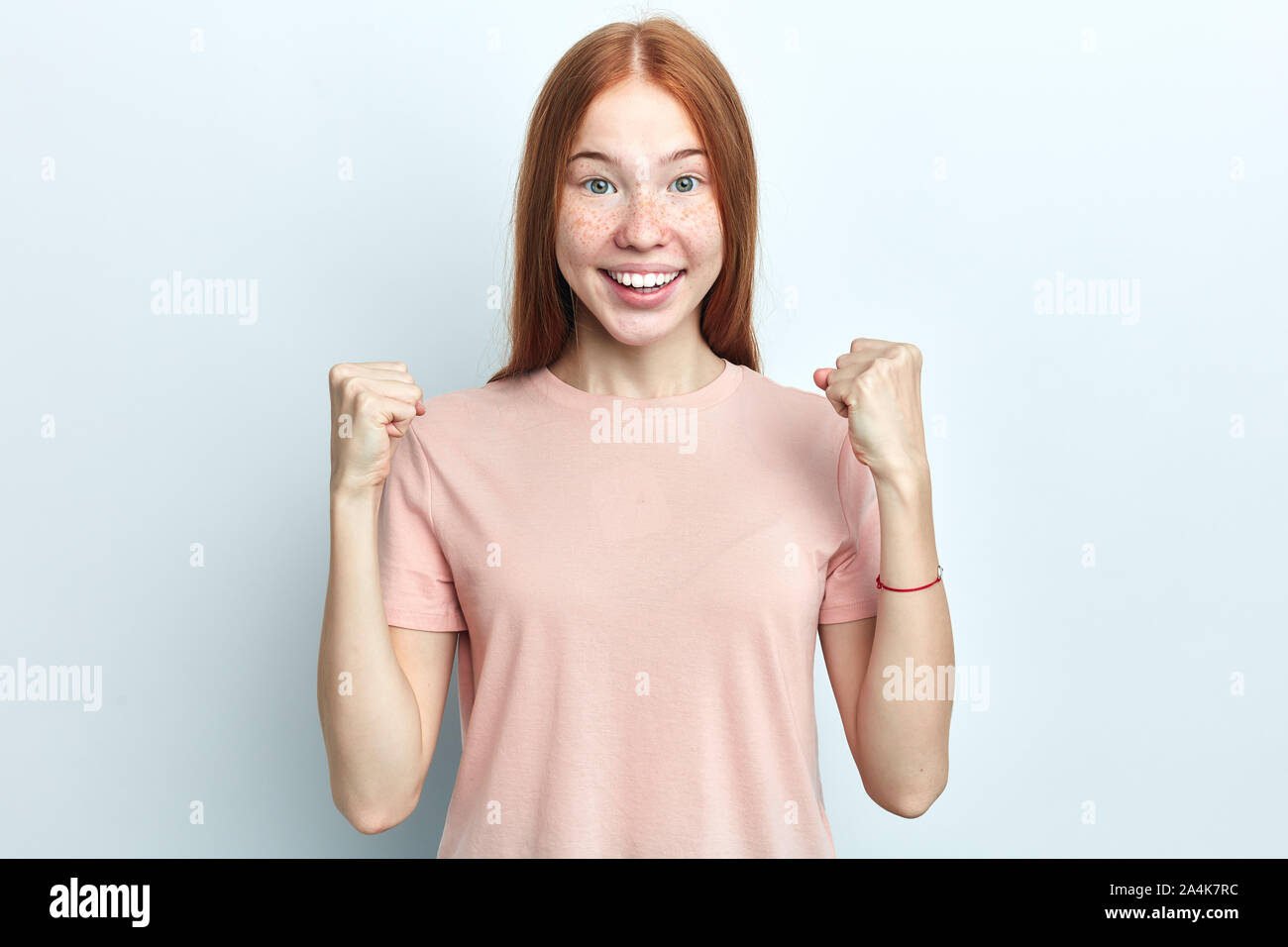 excited student with overjoyed expression, rejoices her success, keeps ...