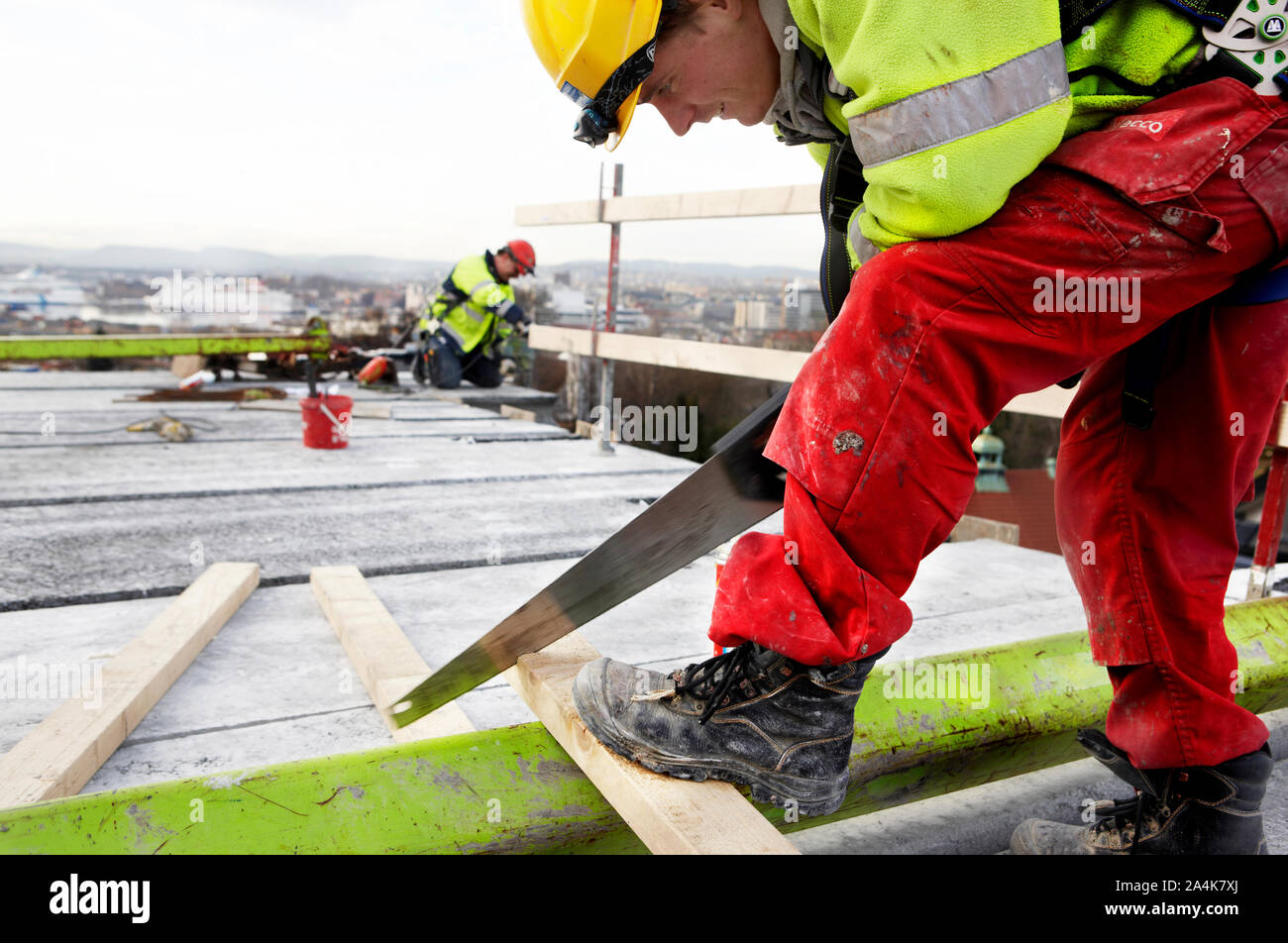 Workmen - Construction worker with saw Stock Photo - Alamy
