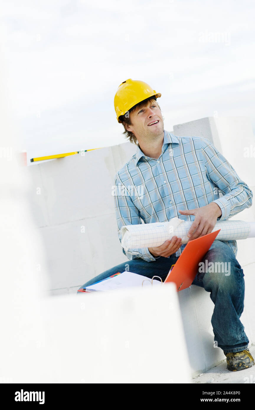 Workman at a construction site Stock Photo - Alamy