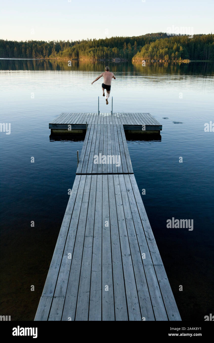 Man jumping into lake Stock Photo - Alamy