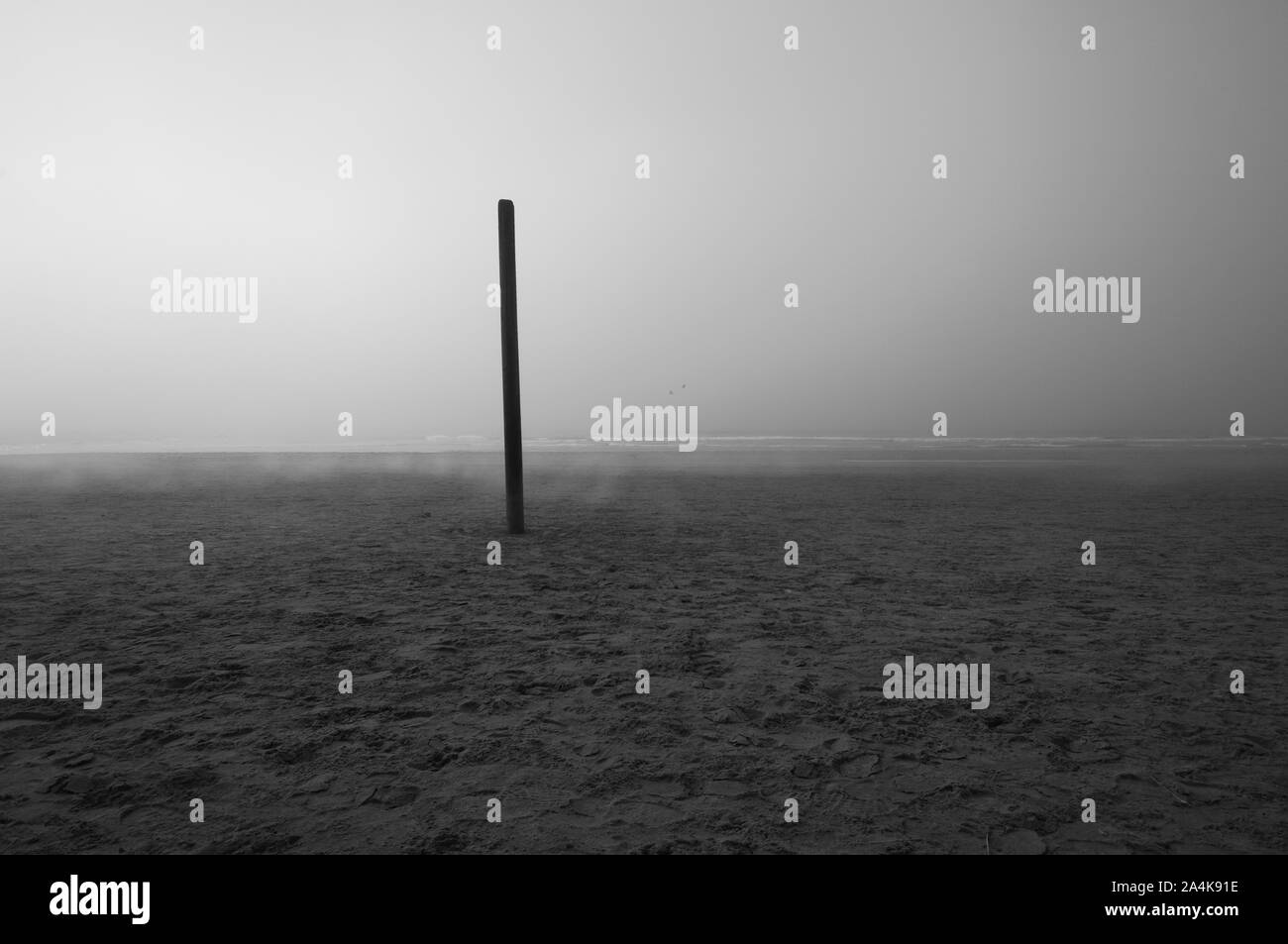 Upright pole on a beach Stock Photo - Alamy