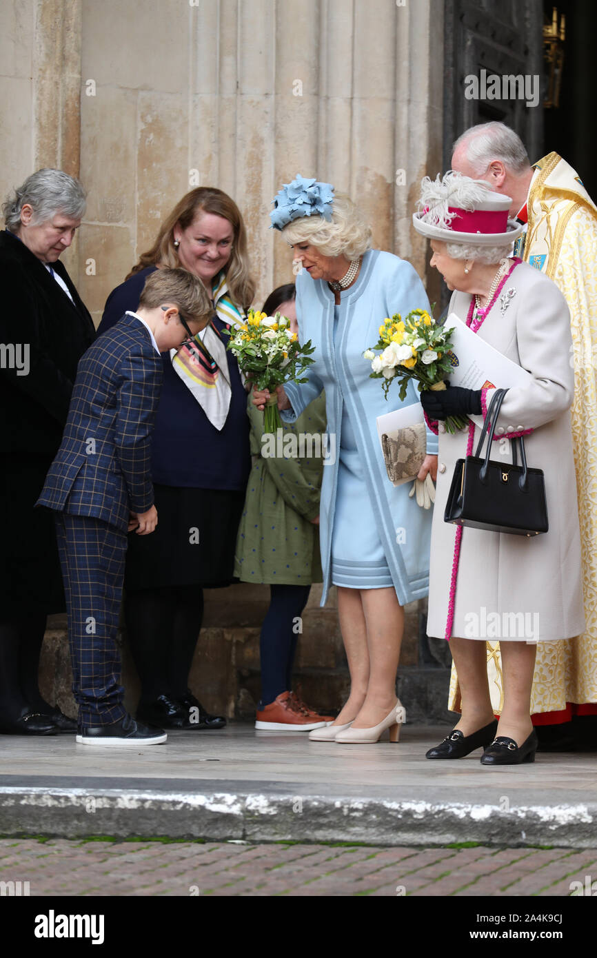 Queen Elizabeth II, accompanied by the Duchess of Cornwall, both are ...
