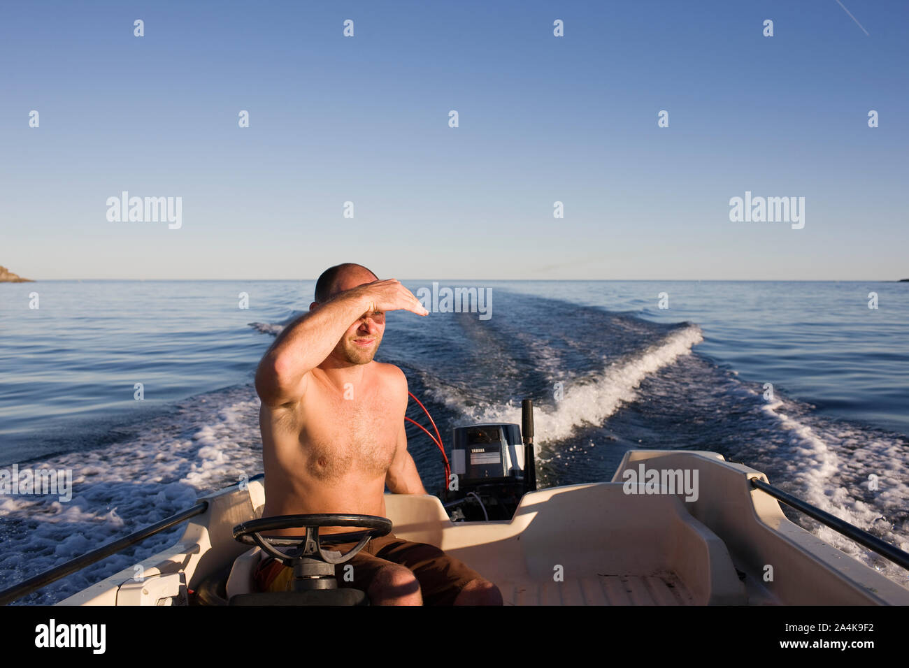 Man driving motor boat Stock Photo - Alamy