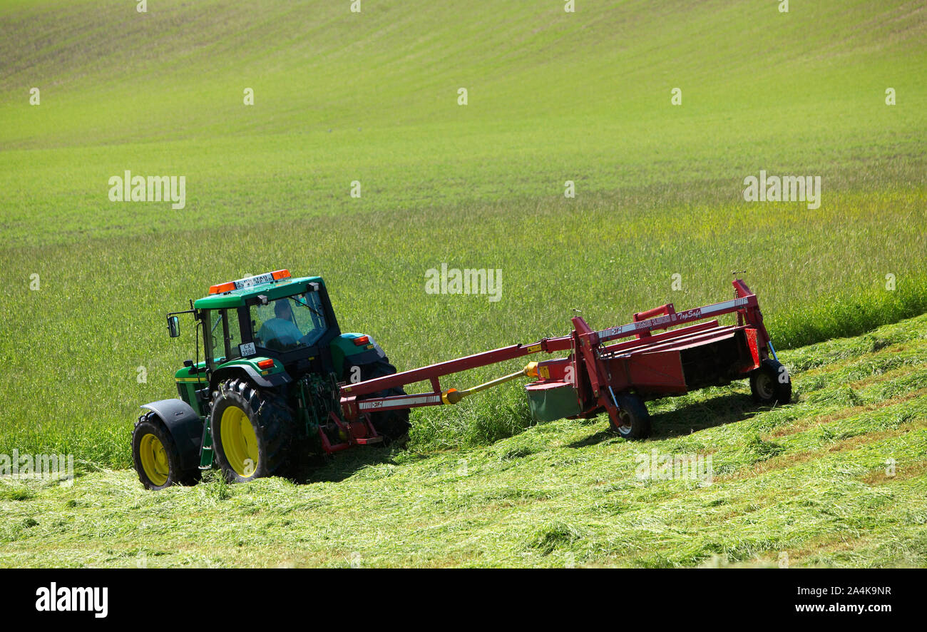 Tractor in a field in Norway Stock Photo - Alamy