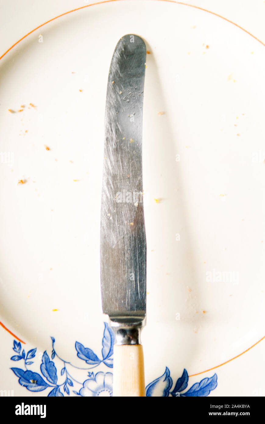 Patterned plate with old knife Stock Photo - Alamy