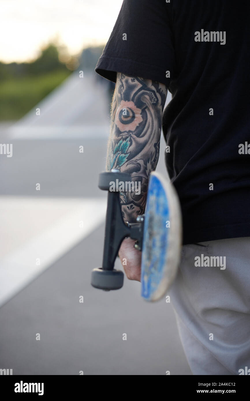 Man with surfboard and tattoos Stock Photo - Alamy