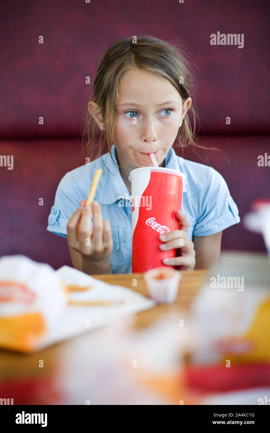 Girl eating fast food Stock Photo - Alamy