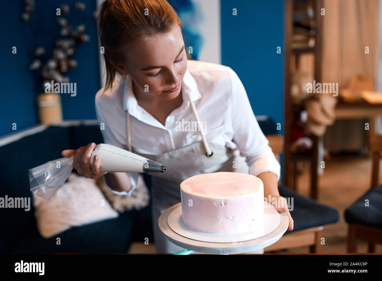 serious talented girl concentrated on cooking, learning to bake cake ...