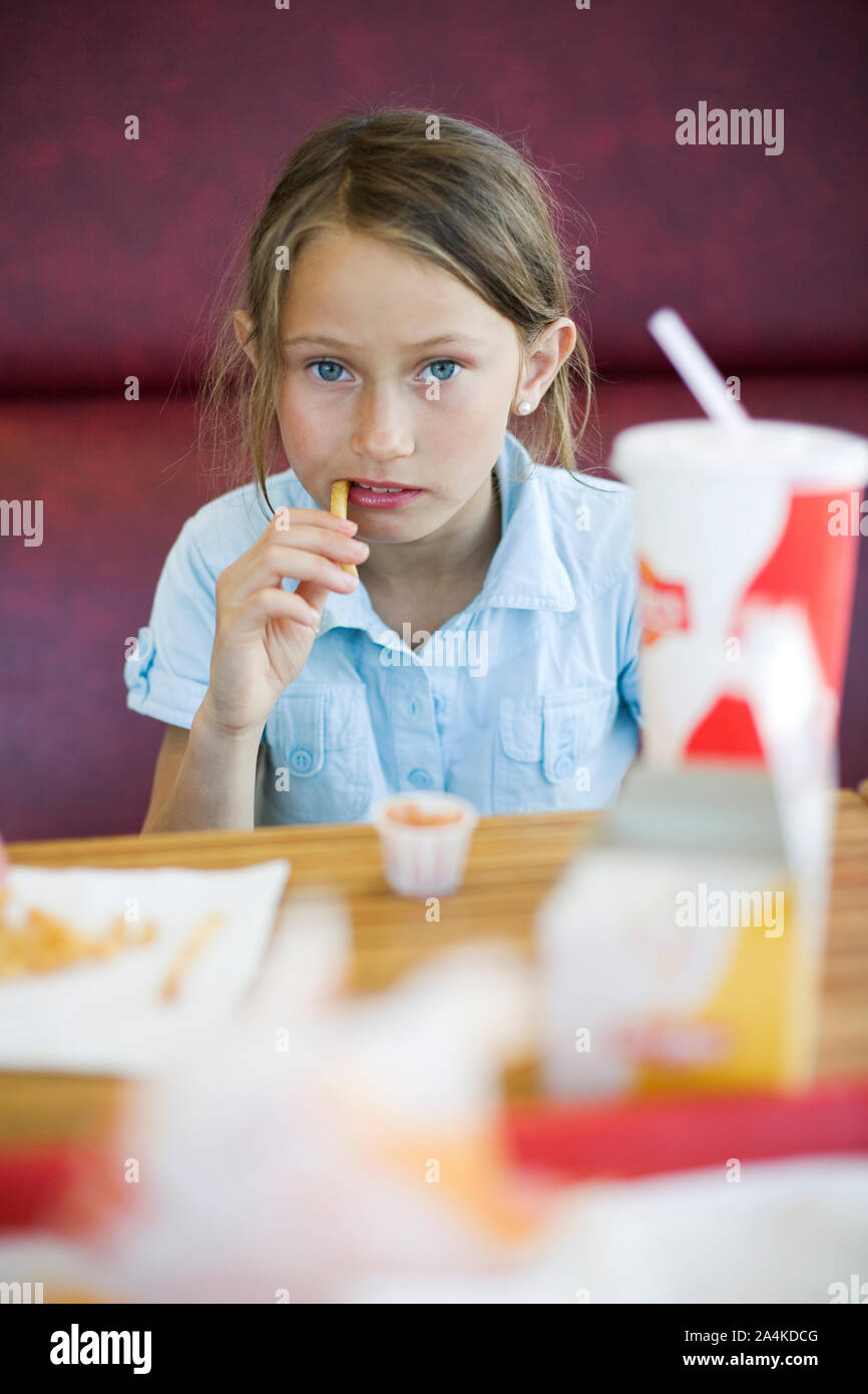 Girl eating fast food Stock Photo - Alamy