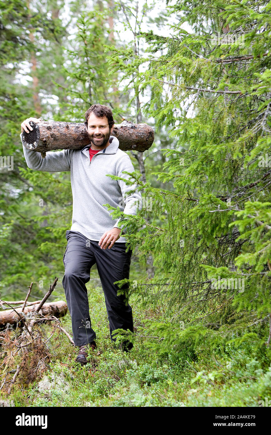 Man Carrying Logs, Outdoors Stock Photo - Alamy