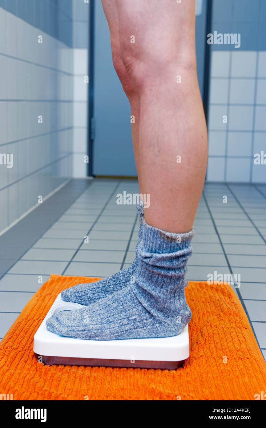 Man on bathroom scales hi-res stock photography and images - Alamy