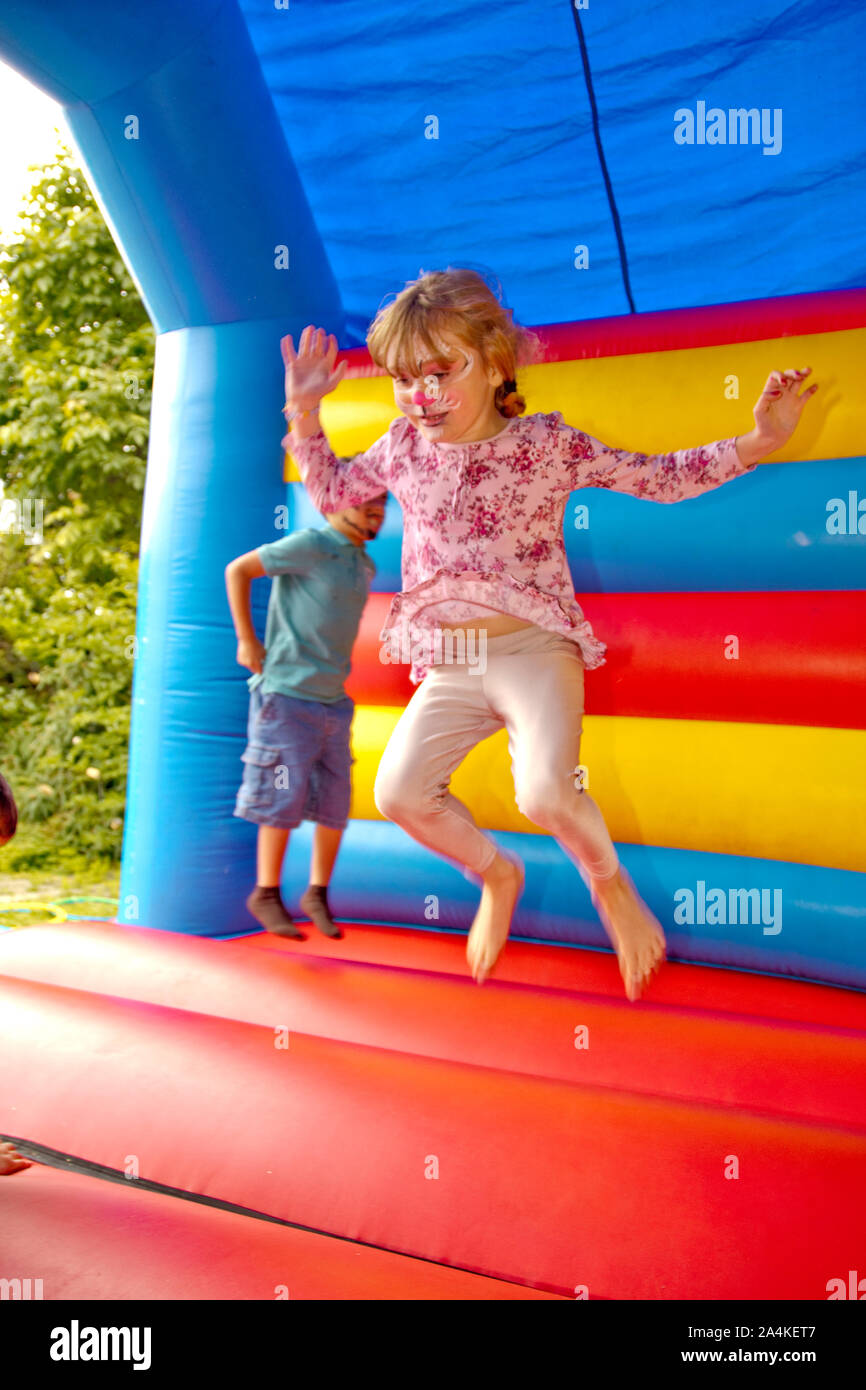 Sheffield, UK: 1 Aug 2016 :a young girl jumping on a bouncy castle ...