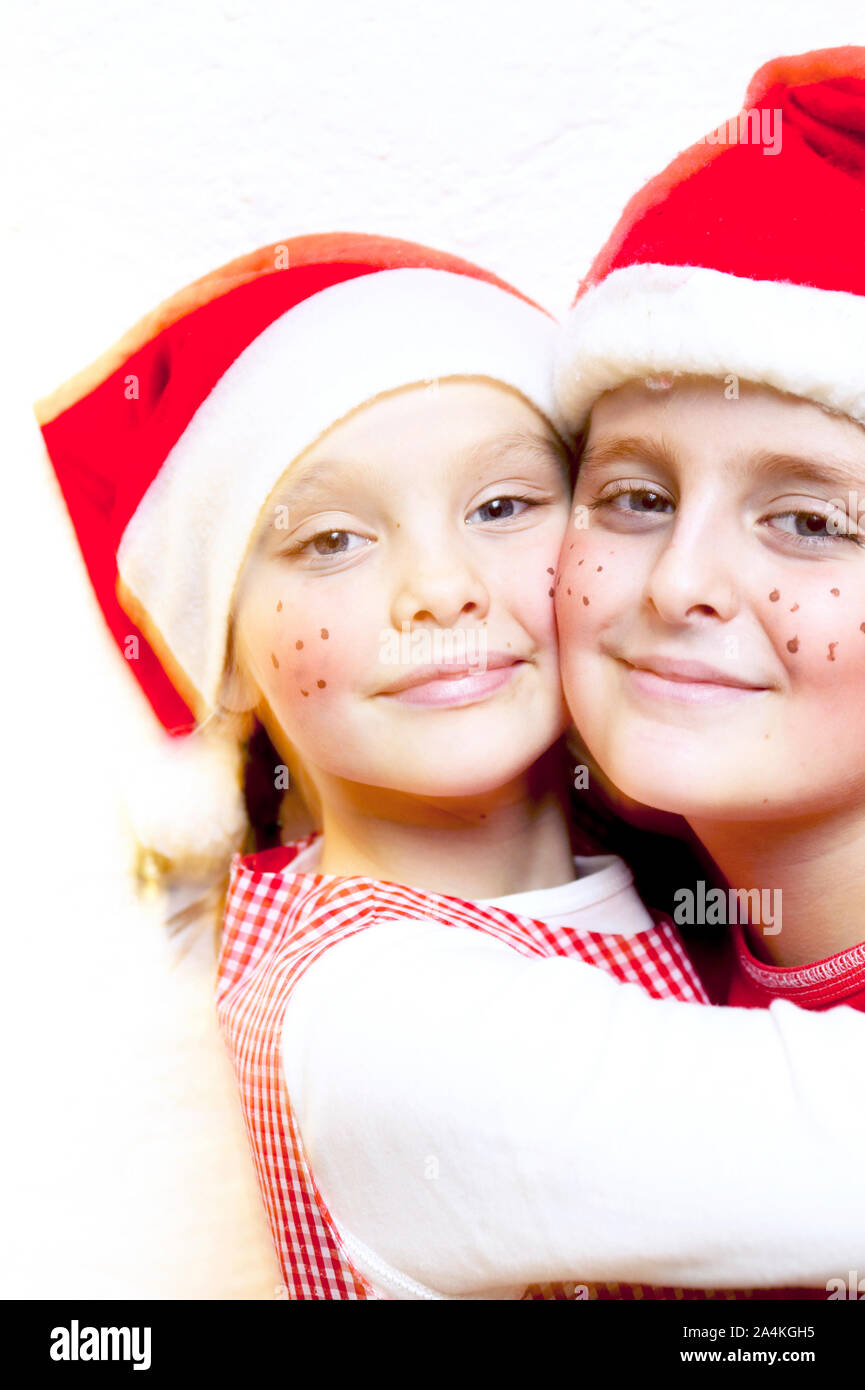 Girls with red cheeks giving each other a hug Stock Photo - Alamy