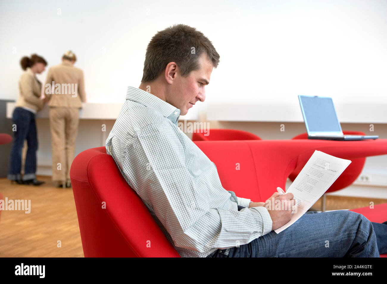 Man reading document Stock Photo - Alamy
