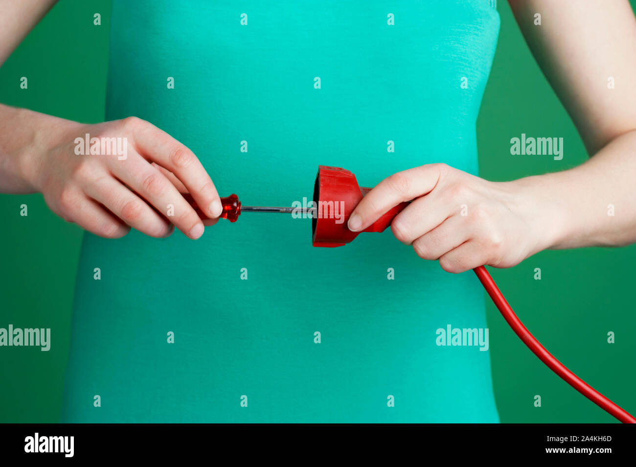 Fixing plug with screwdriver Stock Photo - Alamy