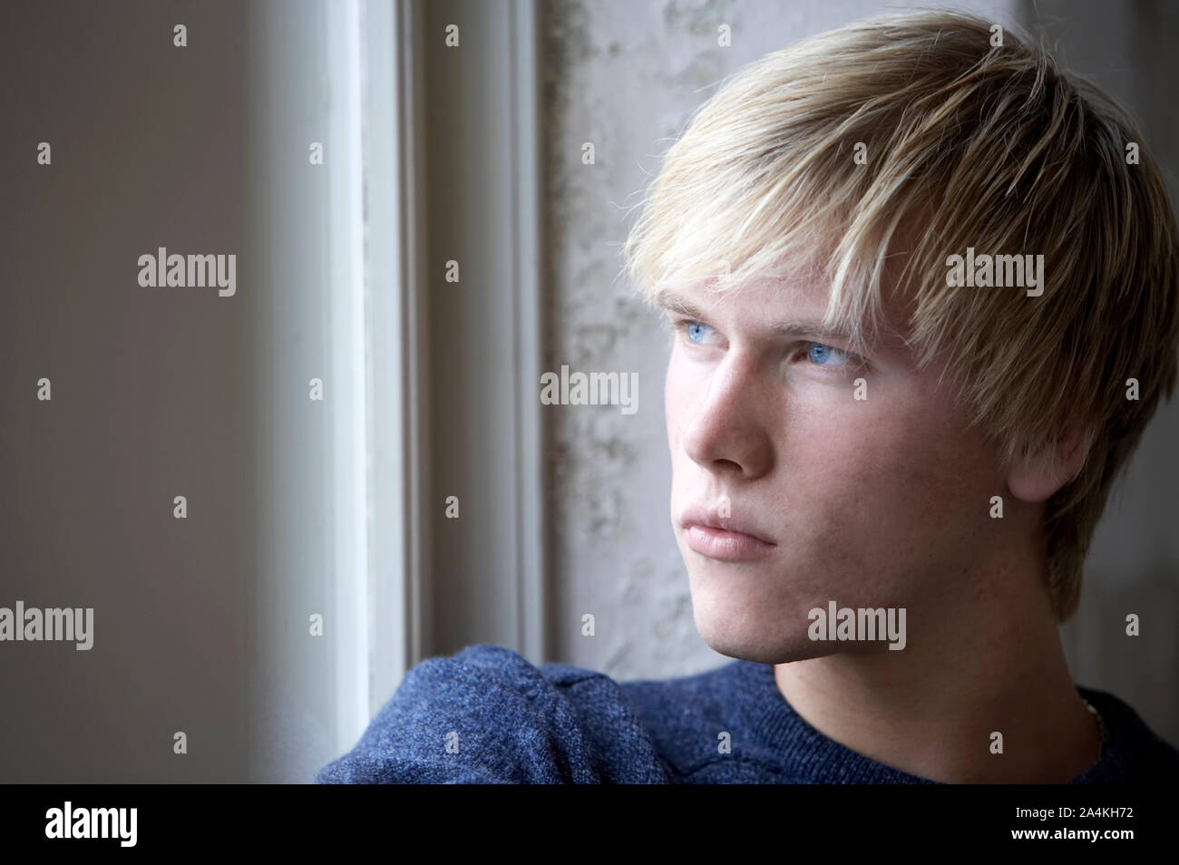 Teenager looking out of the window Stock Photo - Alamy