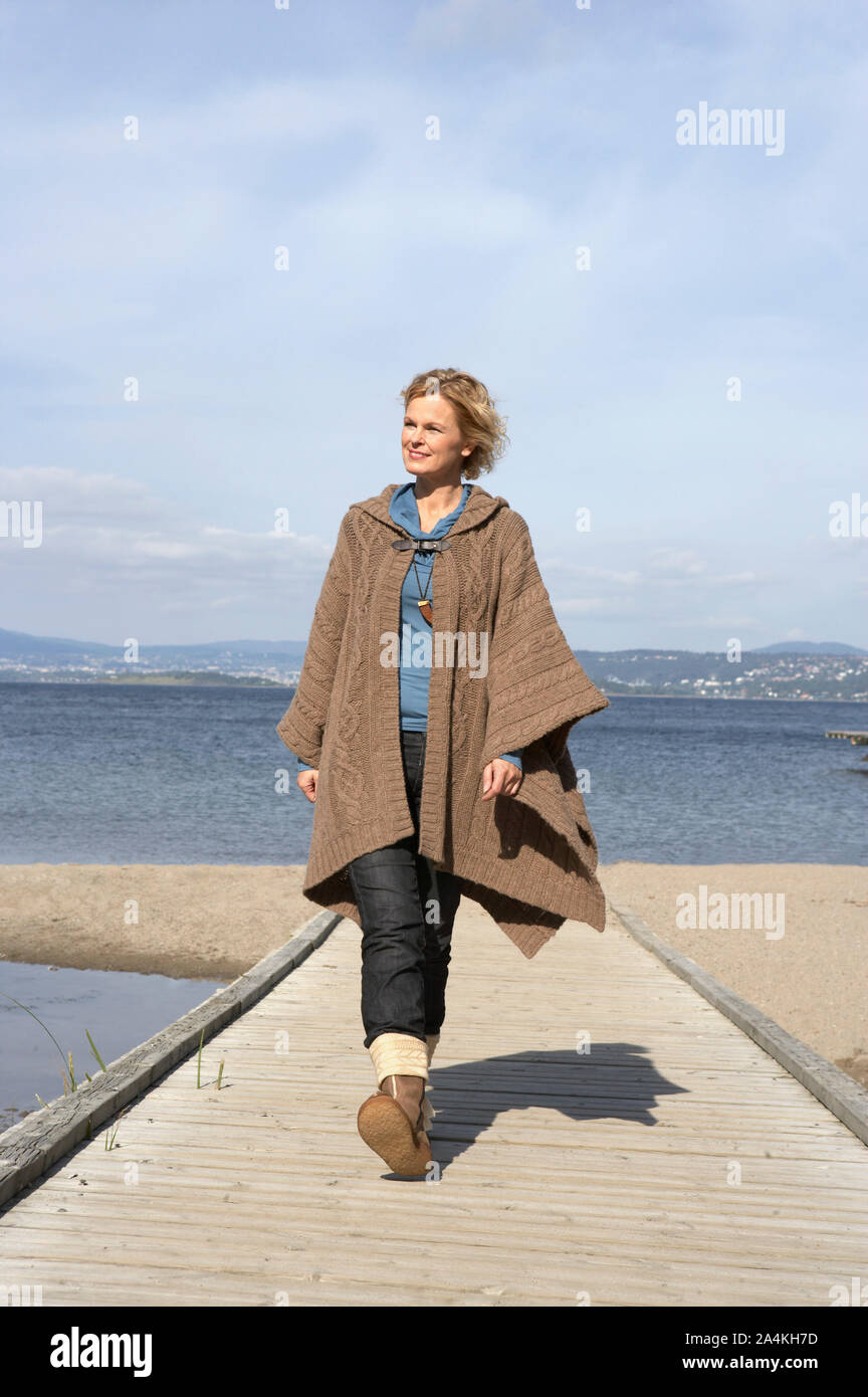 Woman walking by the sea Stock Photo - Alamy