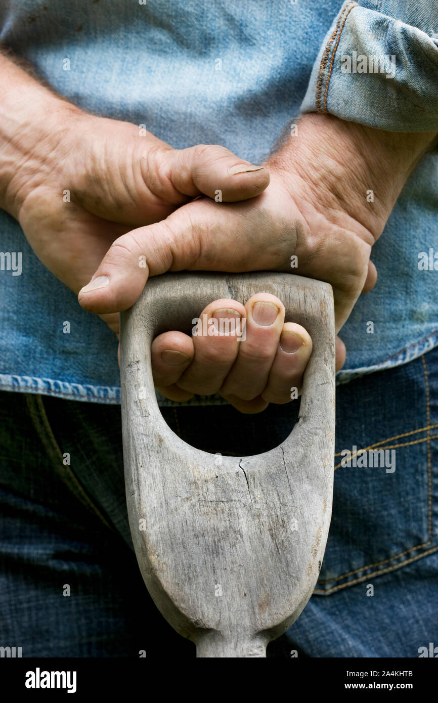 Man holding a spade Stock Photo - Alamy