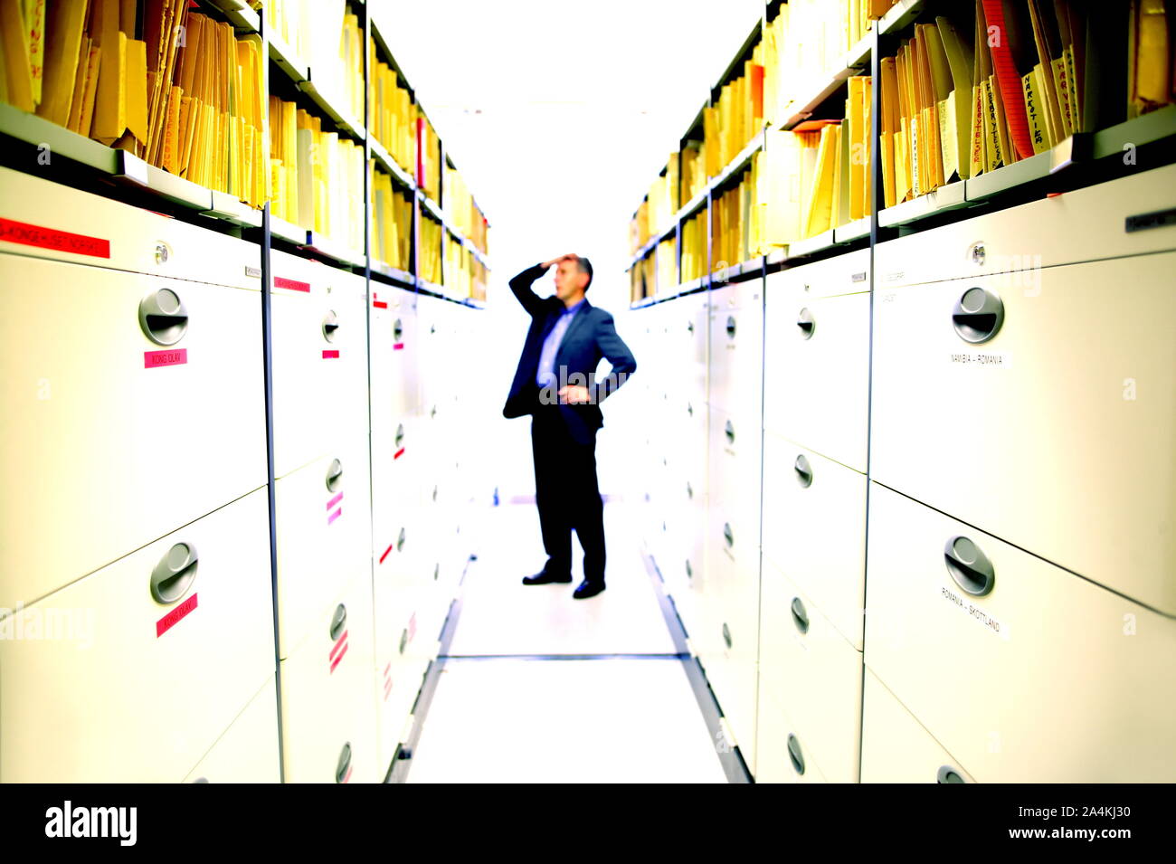 Confused - searching - systems - resigned - drawers Stock Photo - Alamy