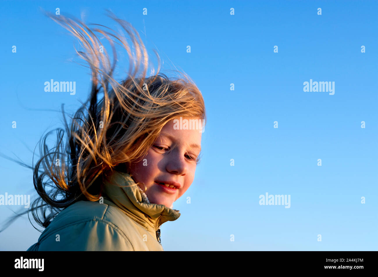 Girl in wind blowing Stock Photo - Alamy