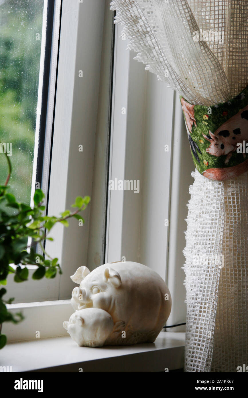 Pig figurines on window sill Stock Photo - Alamy