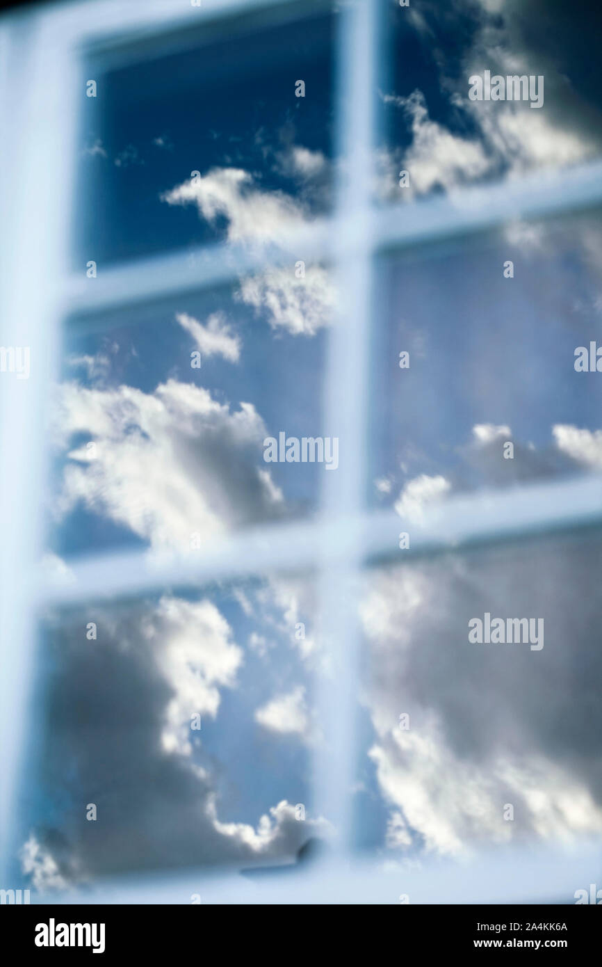 Clouds reflected in window Stock Photo - Alamy