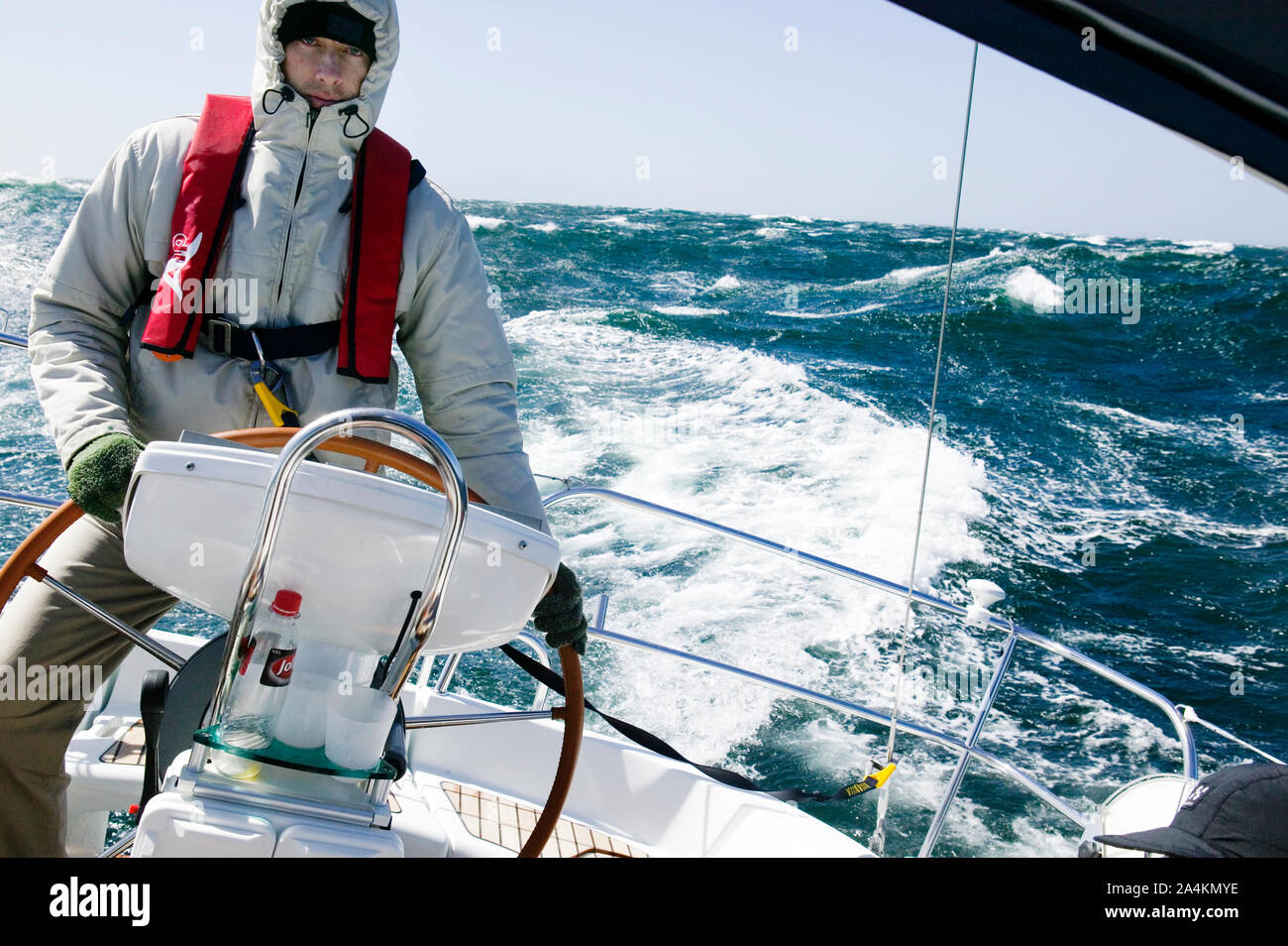 Man in sailing boat Stock Photo - Alamy