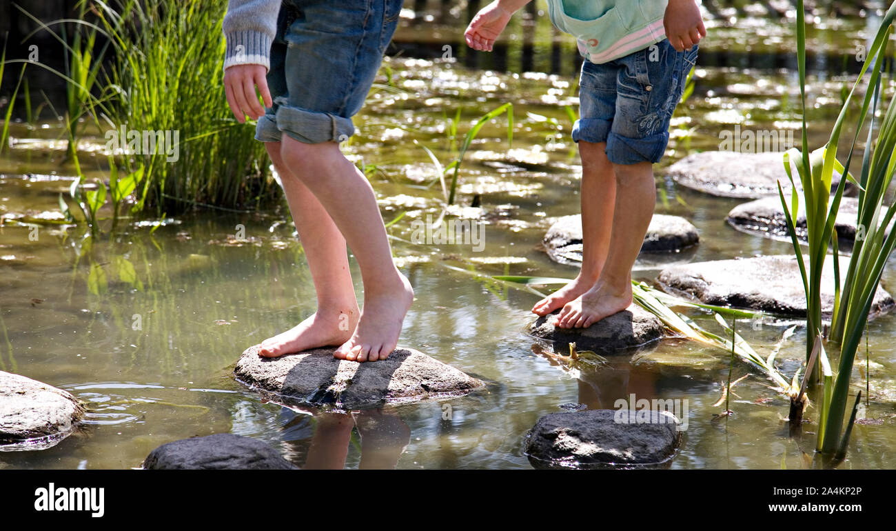 Kids playing in pond Stock Photo - Alamy