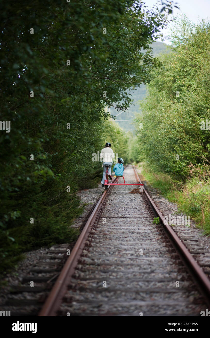Mother and daughter driving "dressin" - small carriage - on old railway ...
