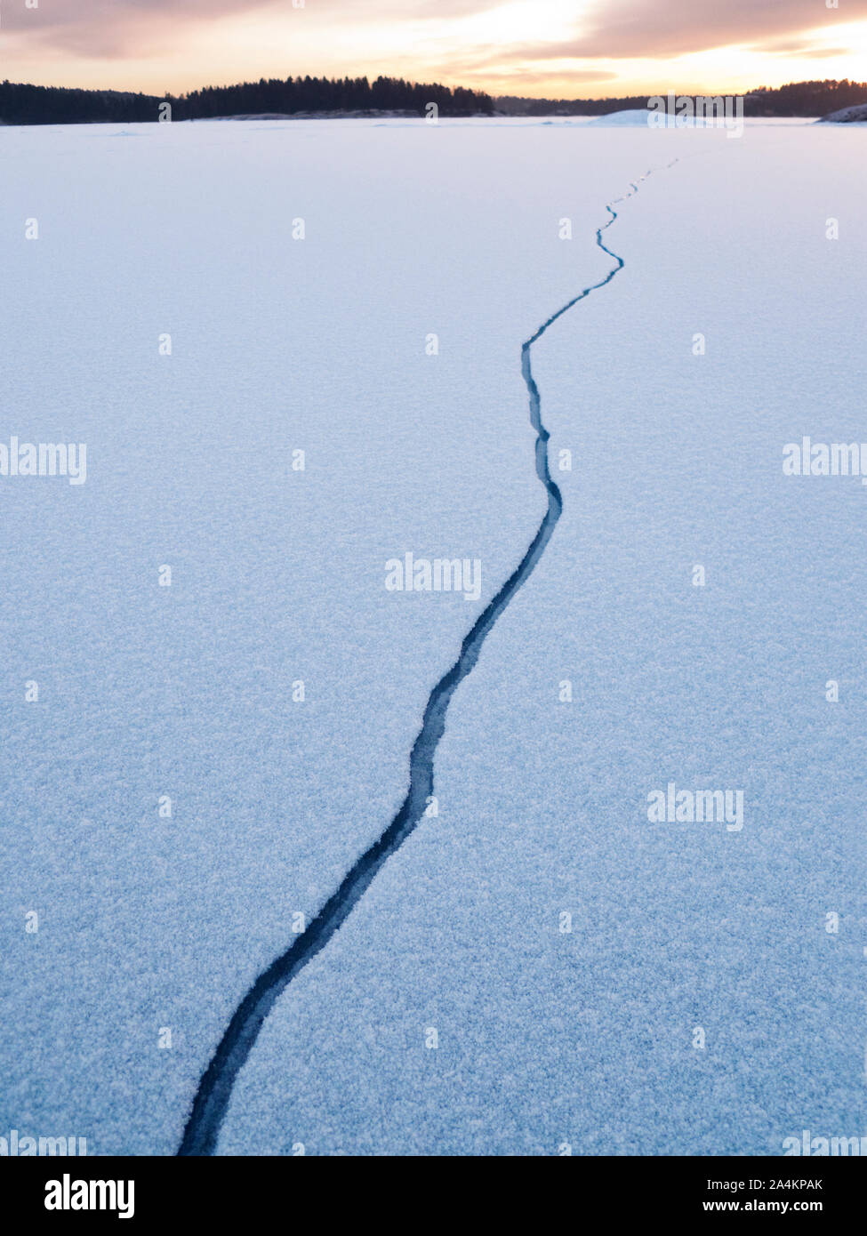 Cracking ice on lake Stock Photo - Alamy