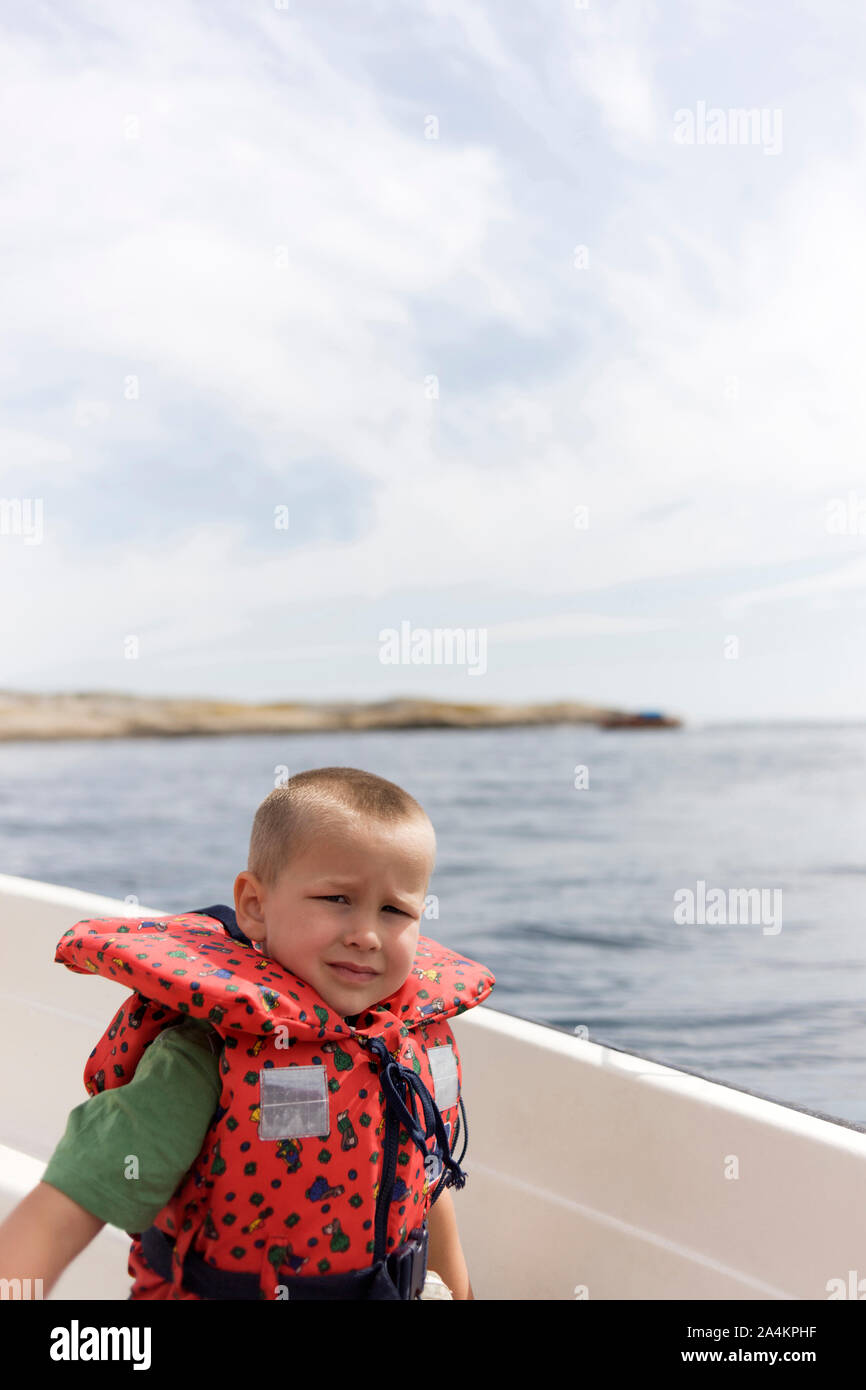 Child wearing life jacket on boat hi-res stock photography and images ...