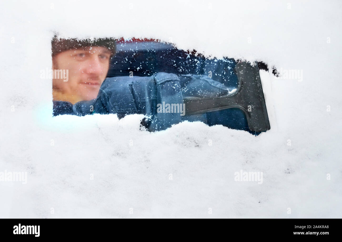 Man wiping/scratching/scraping snow and ice from the windscreen Stock ...