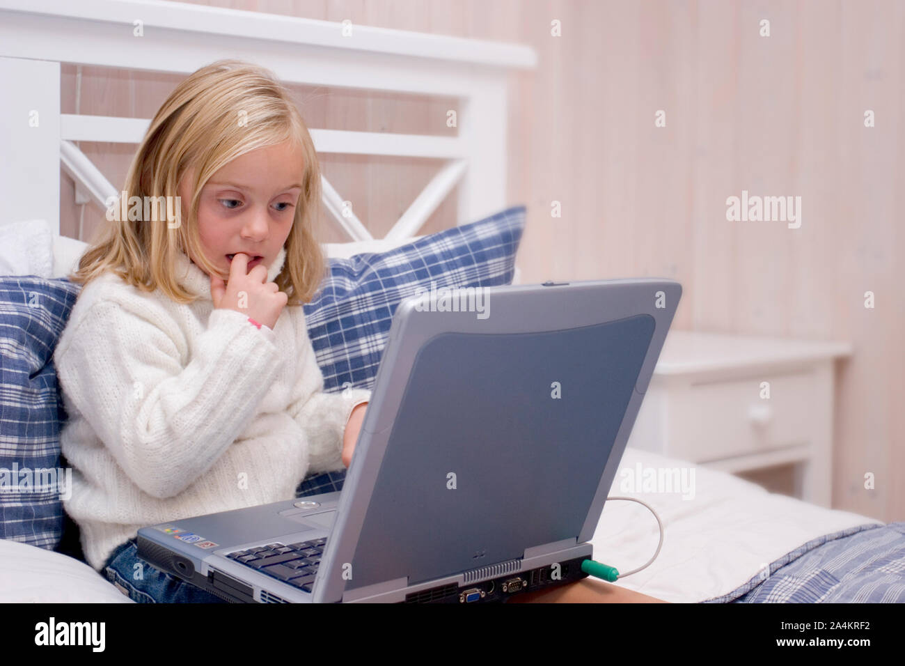 Girl with laptop in bed Stock Photo - Alamy