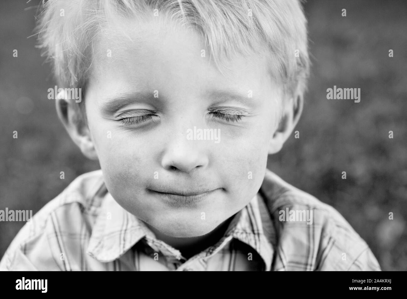 Boy with expectations - eyes shut Stock Photo - Alamy