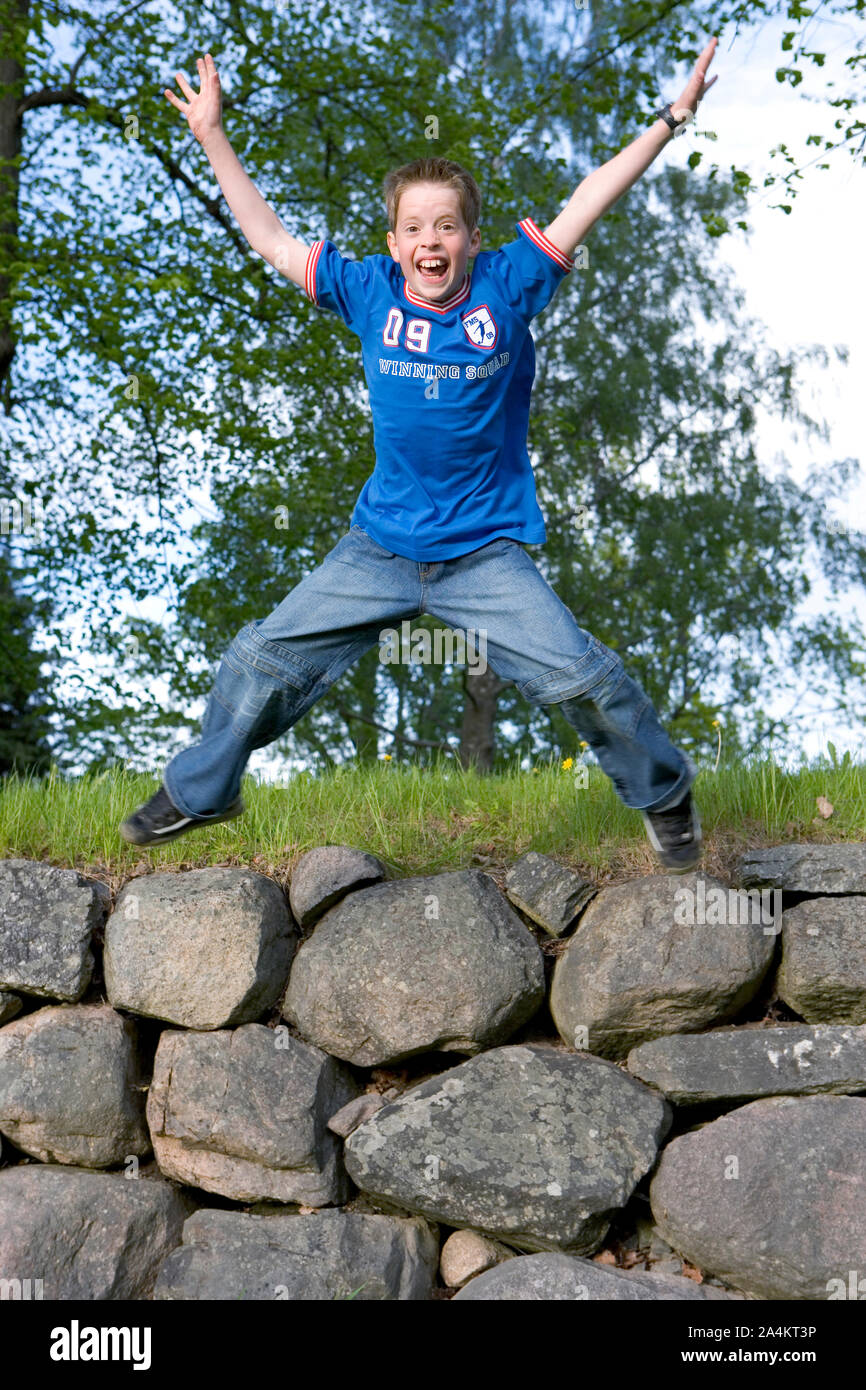 Happy boy jumping Stock Photo - Alamy