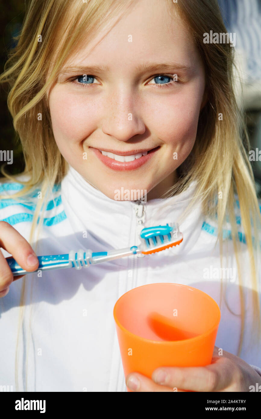 Girl brushing her teeth Stock Photo - Alamy