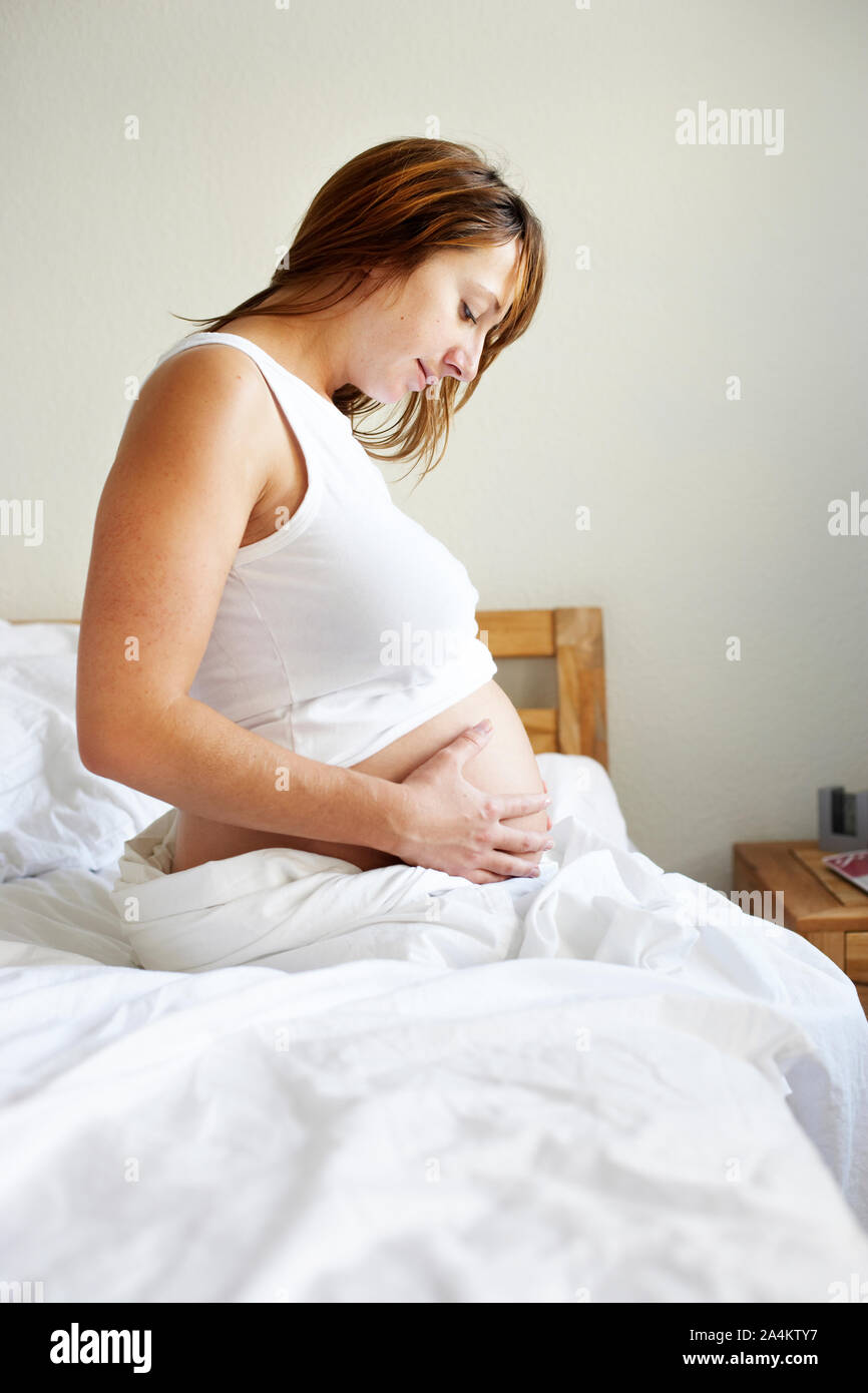 Pregnant Woman in Bed Stock Photo - Alamy